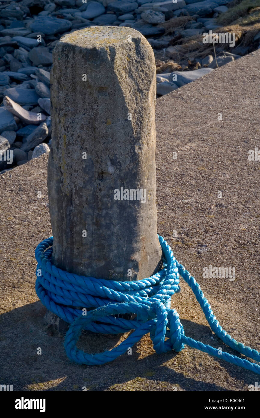 Stone pillar on quayside with blue nylon rope Stock Photo - Alamy