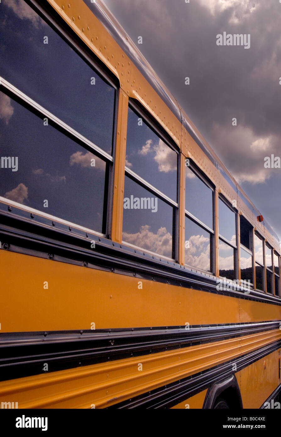 yellow school bus with clouds reflecting off windows Stock Photo - Alamy