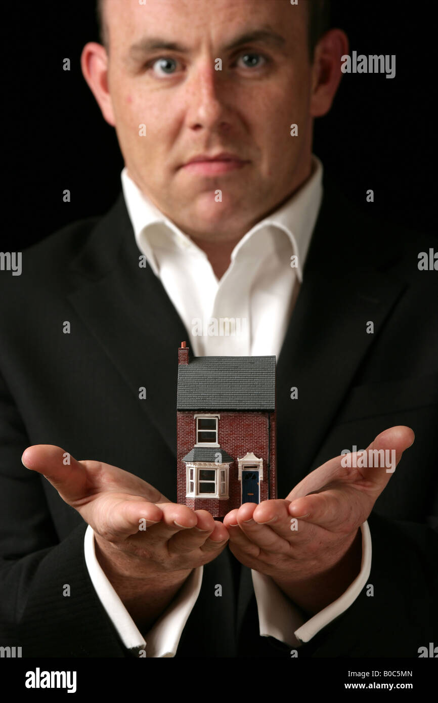 "man holding a model house Stock Photo - Alamy