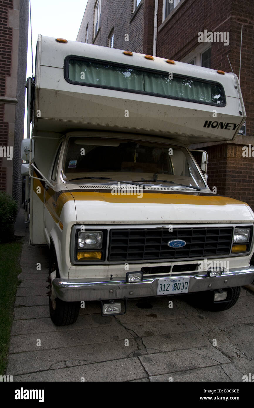 Ford camper van with a top wedged bewteen two apartment buildings ...