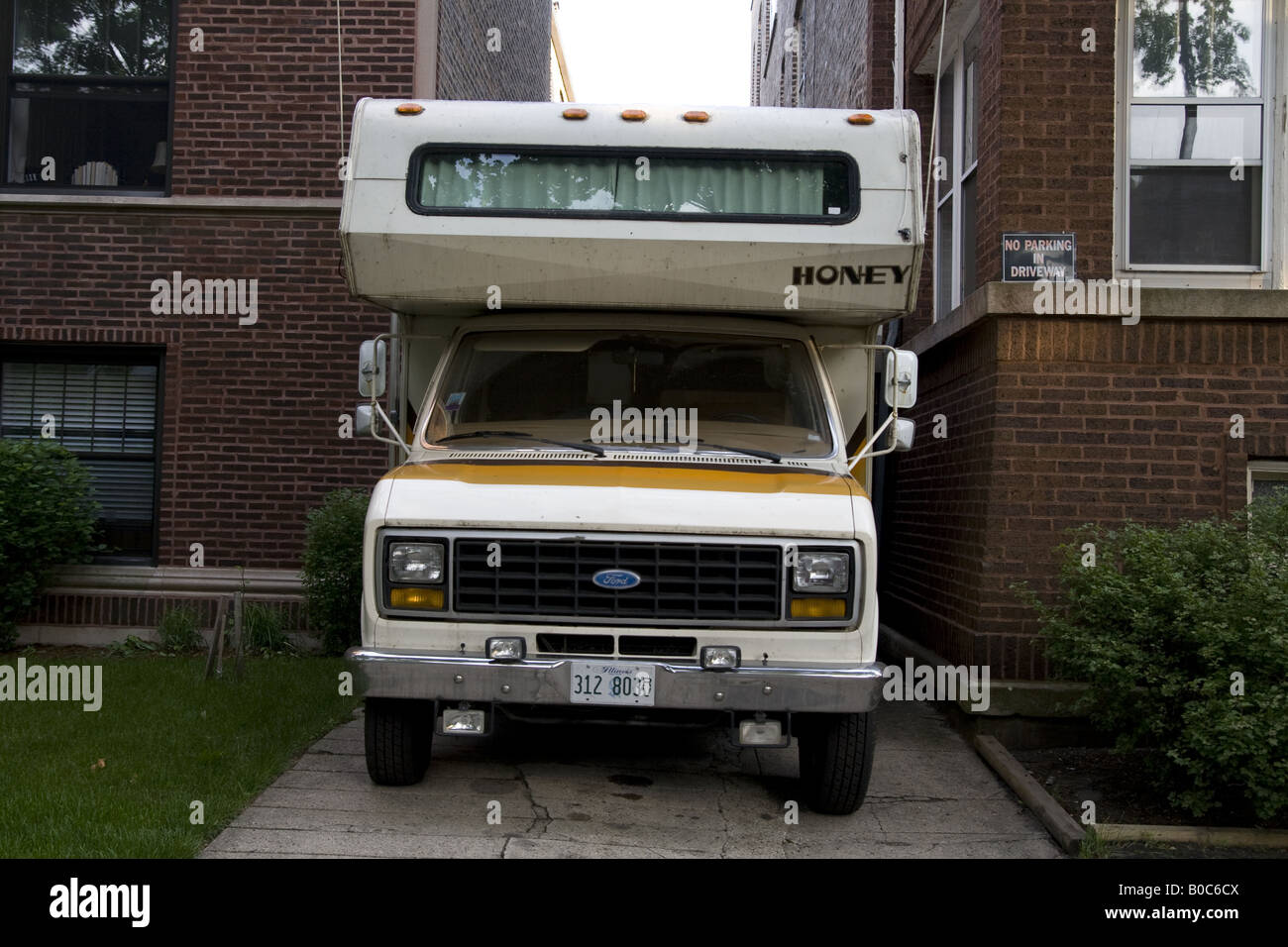 Ford camper van with a top wedged bewteen two apartment buildings ...