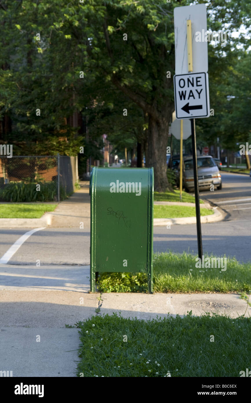 Green mail box on the street in Chicago IL next to one way sign Stock ...
