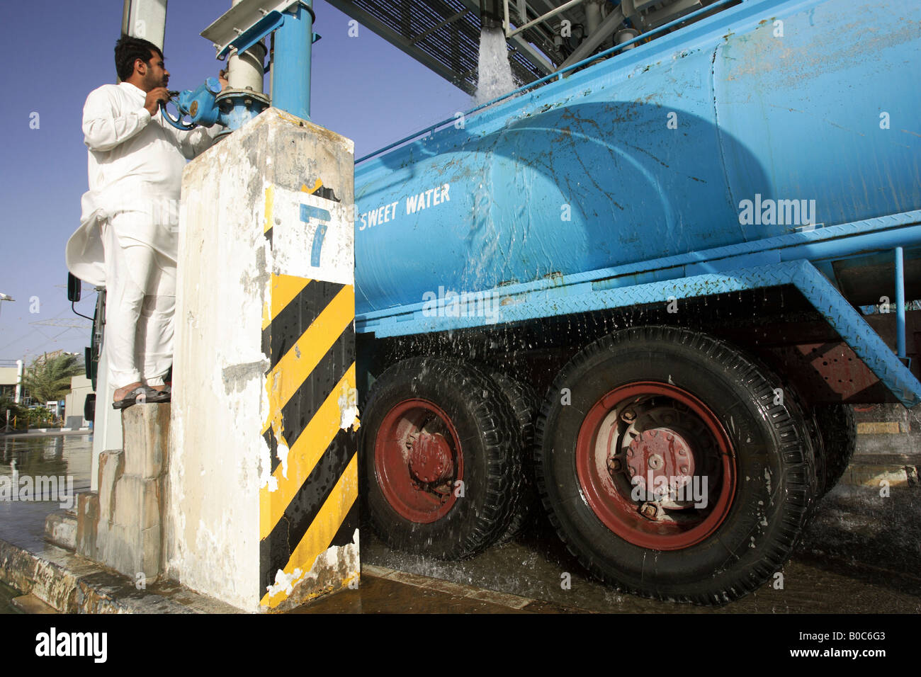 A water lorry being loaded with water, Dubai, United Arab Emirates ...