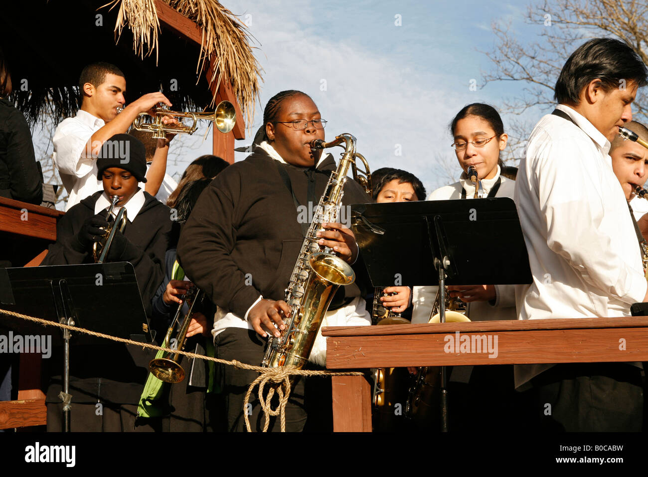 Young high school band musicians play on a float at a Three Kings Day ...
