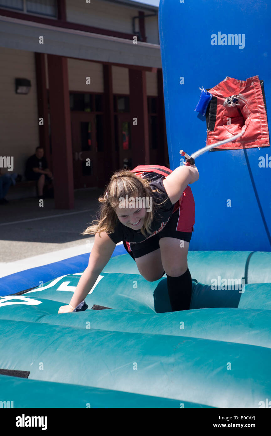 Image of a teenage girl running on One on One Bungee Pull inflatable ...