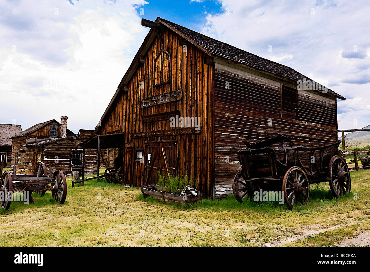 Image of an old Livery Stable with several old wagons next to it and a ...