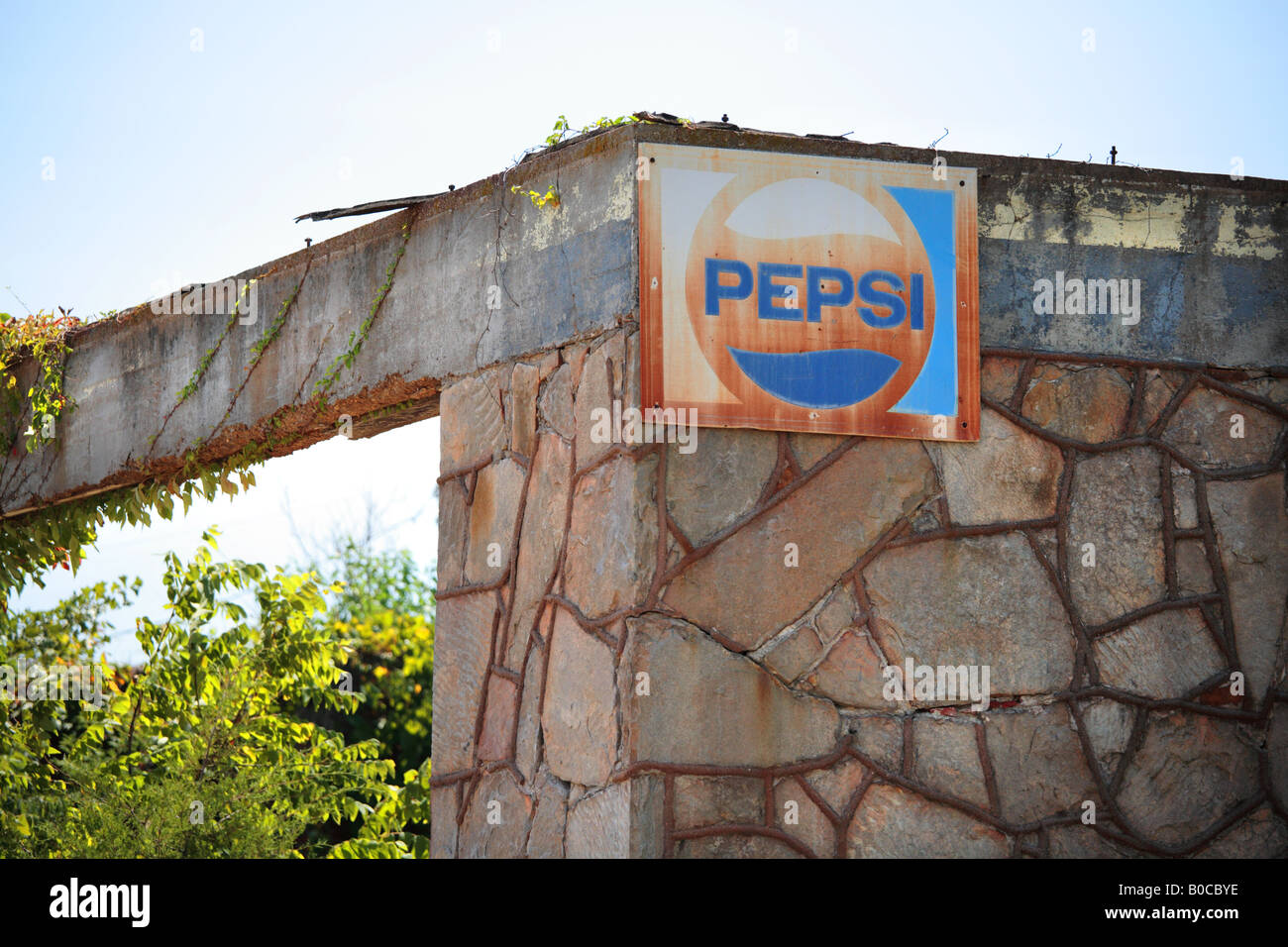 REMNANTS OF AN OLD ROADSIDE BUILDING WITH A RUSTY PEPSI SIGN ON THE ...