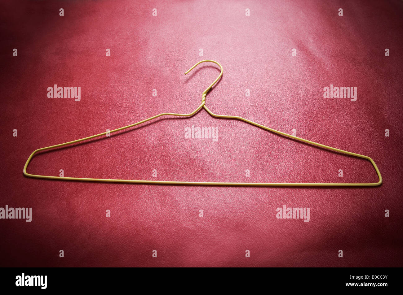 One yellow metal hanger Stock Photo - Alamy