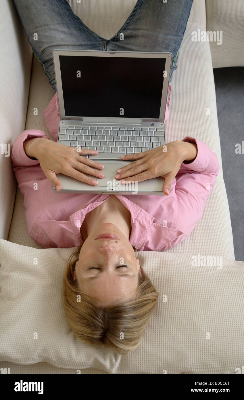 Woman sleeping with laptop Stock Photo - Alamy
