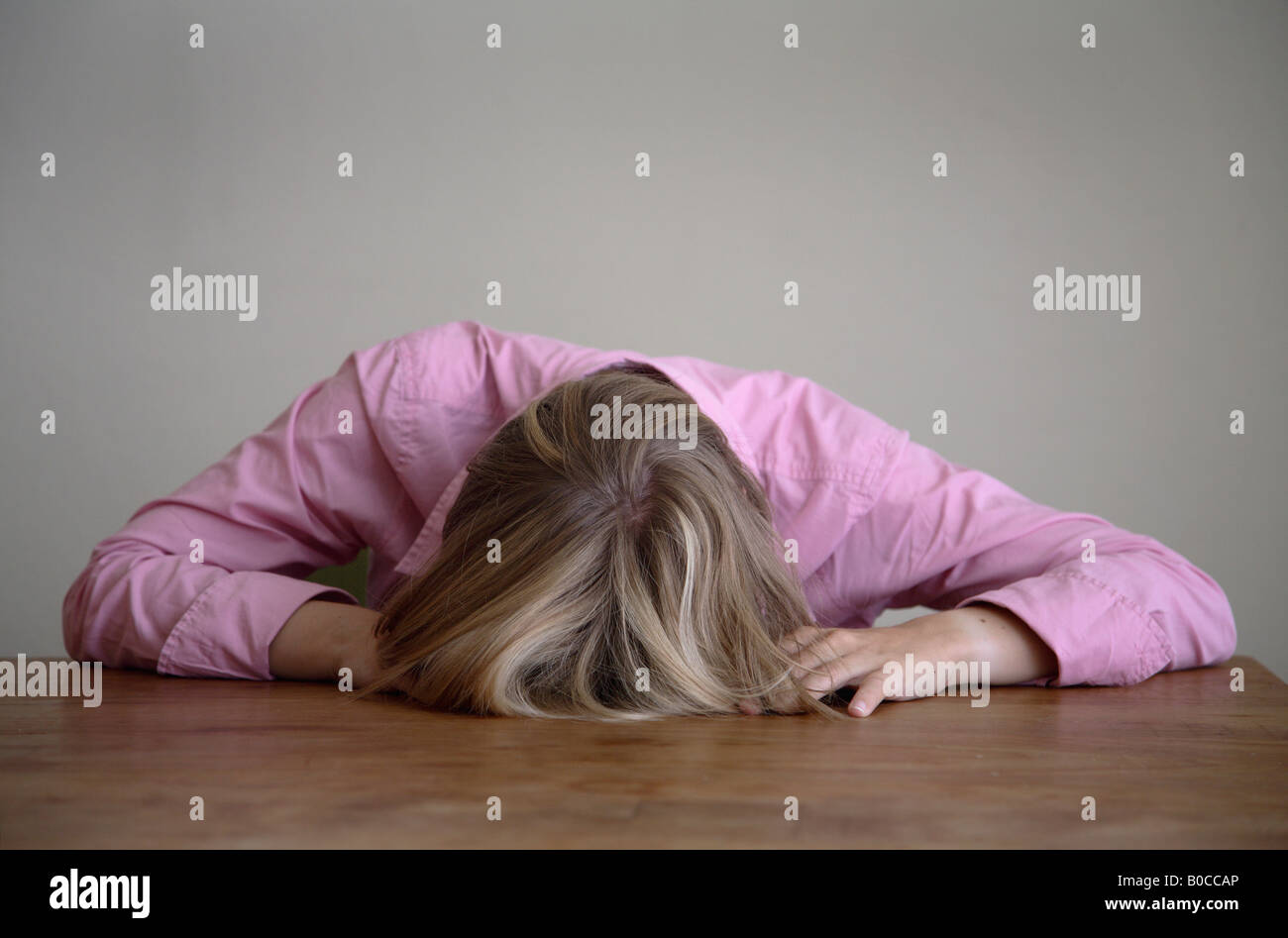 Woman sleeping at a table Stock Photo - Alamy
