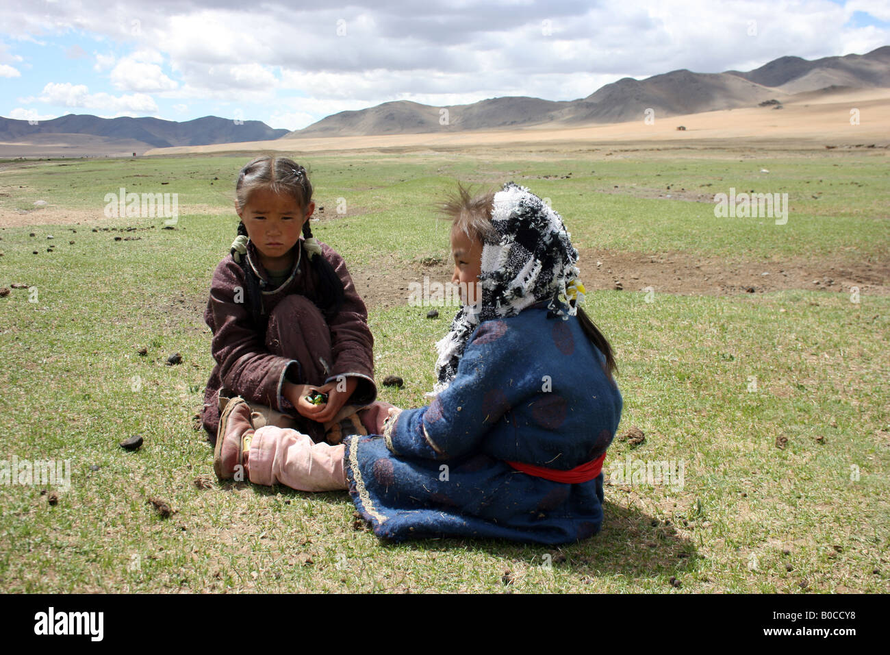 two girls sitting in the midst of steppe, Mongolia Stock Photo - Alamy