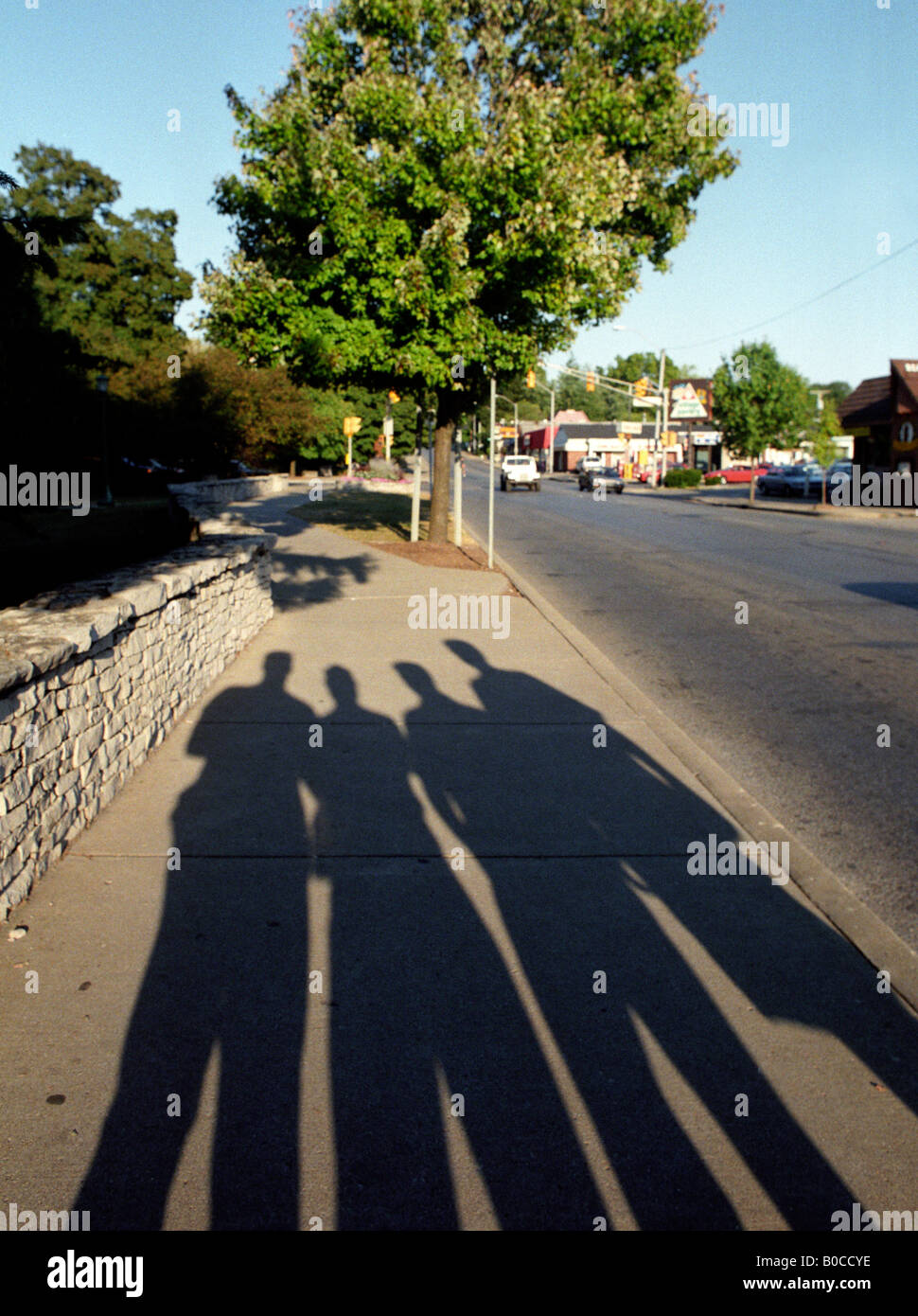 4 men shadows on sidewalk Stock Photo - Alamy