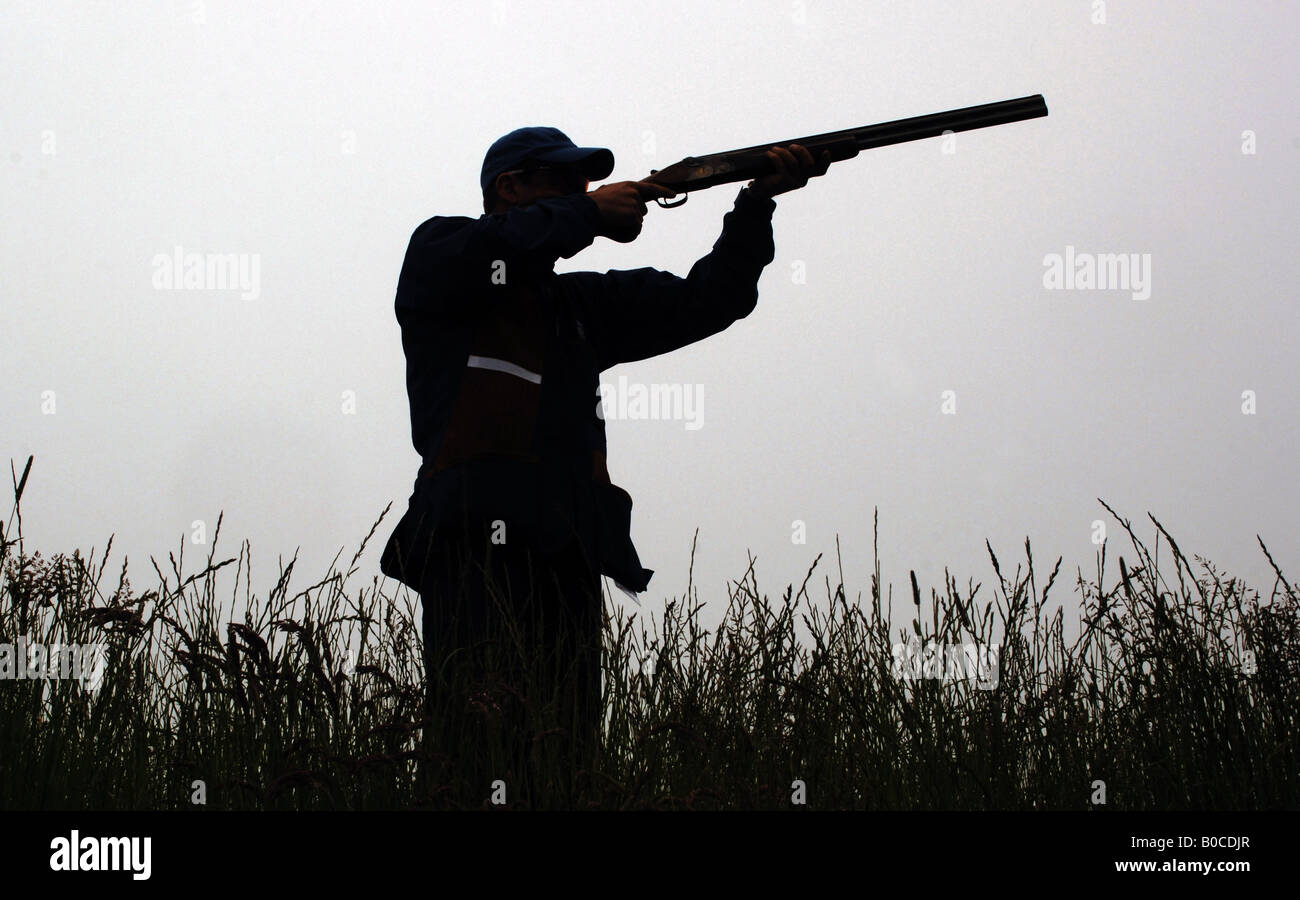 Man aiming with shotgun Stock Photo - Alamy