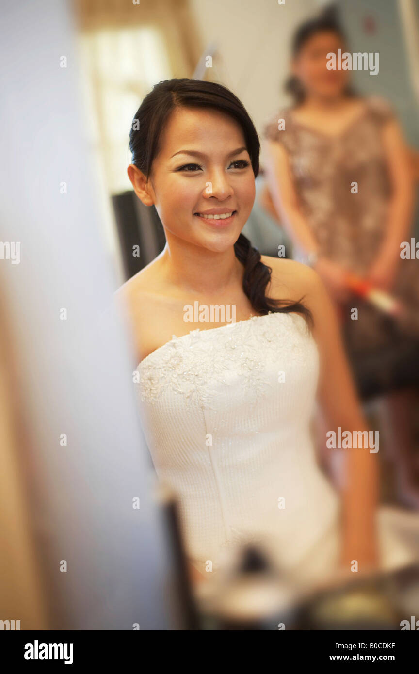 Reflection of bride smiling to her friend Stock Photo - Alamy