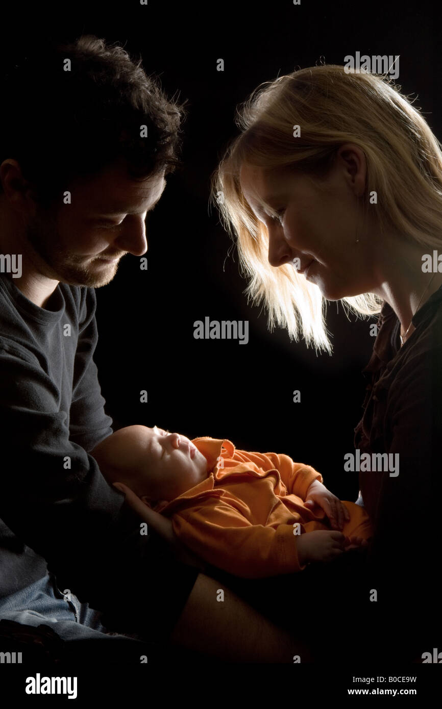 Loving couple holding their newborn little baby Stock Photo - Alamy