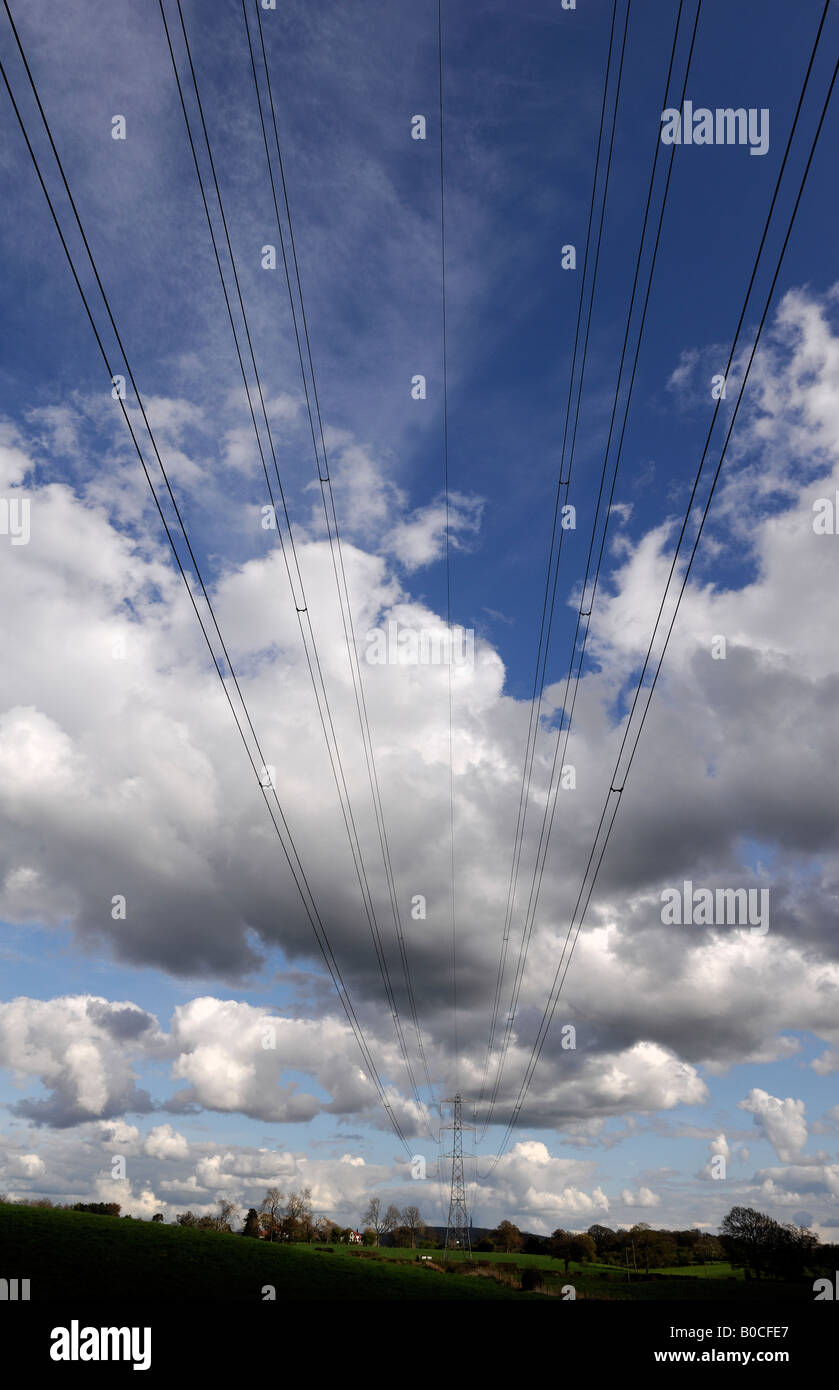 The National Grid.High tension mains power cables and pylon against a ...