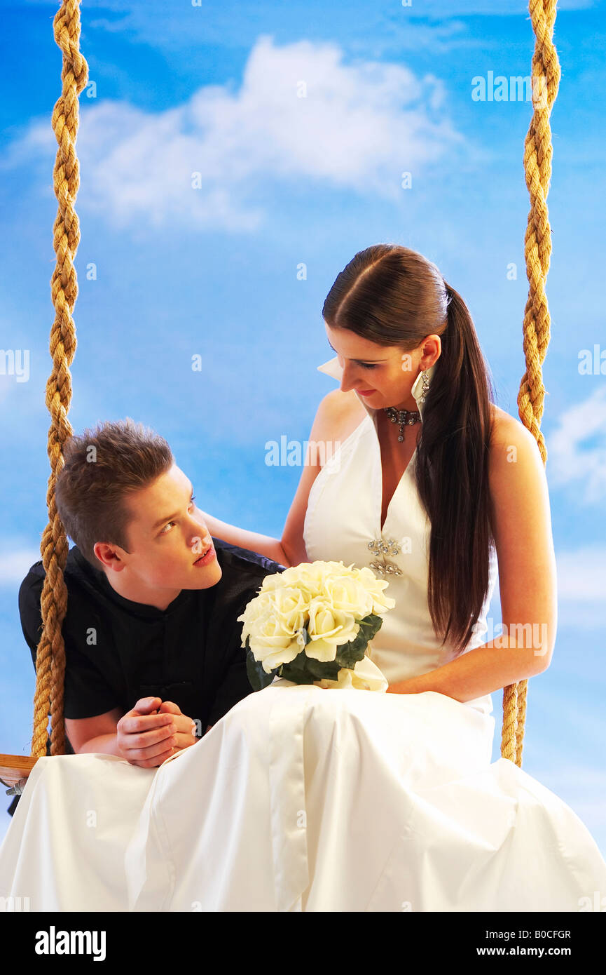 Bridal couple sitting on swing hi-res stock photography and images - Alamy