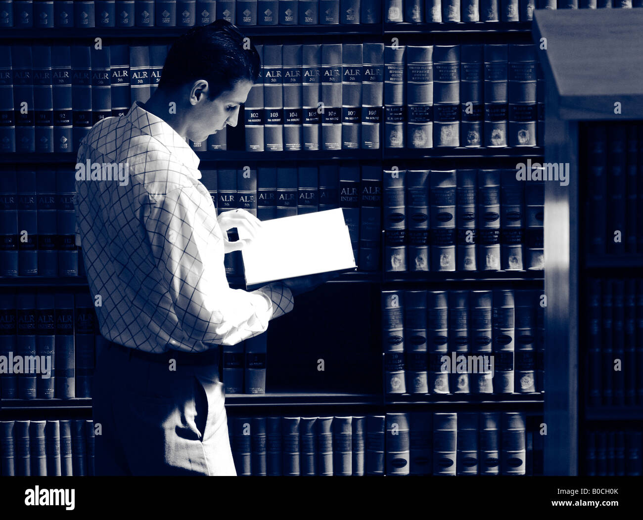 Student/Person reading in a library Stock Photo - Alamy