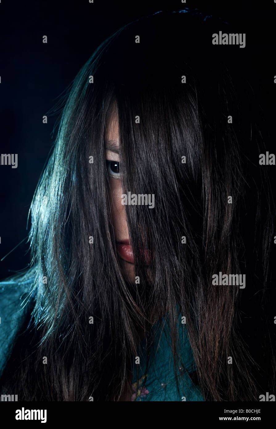 An asian female with long hair looking like a ghost Stock Photo - Alamy