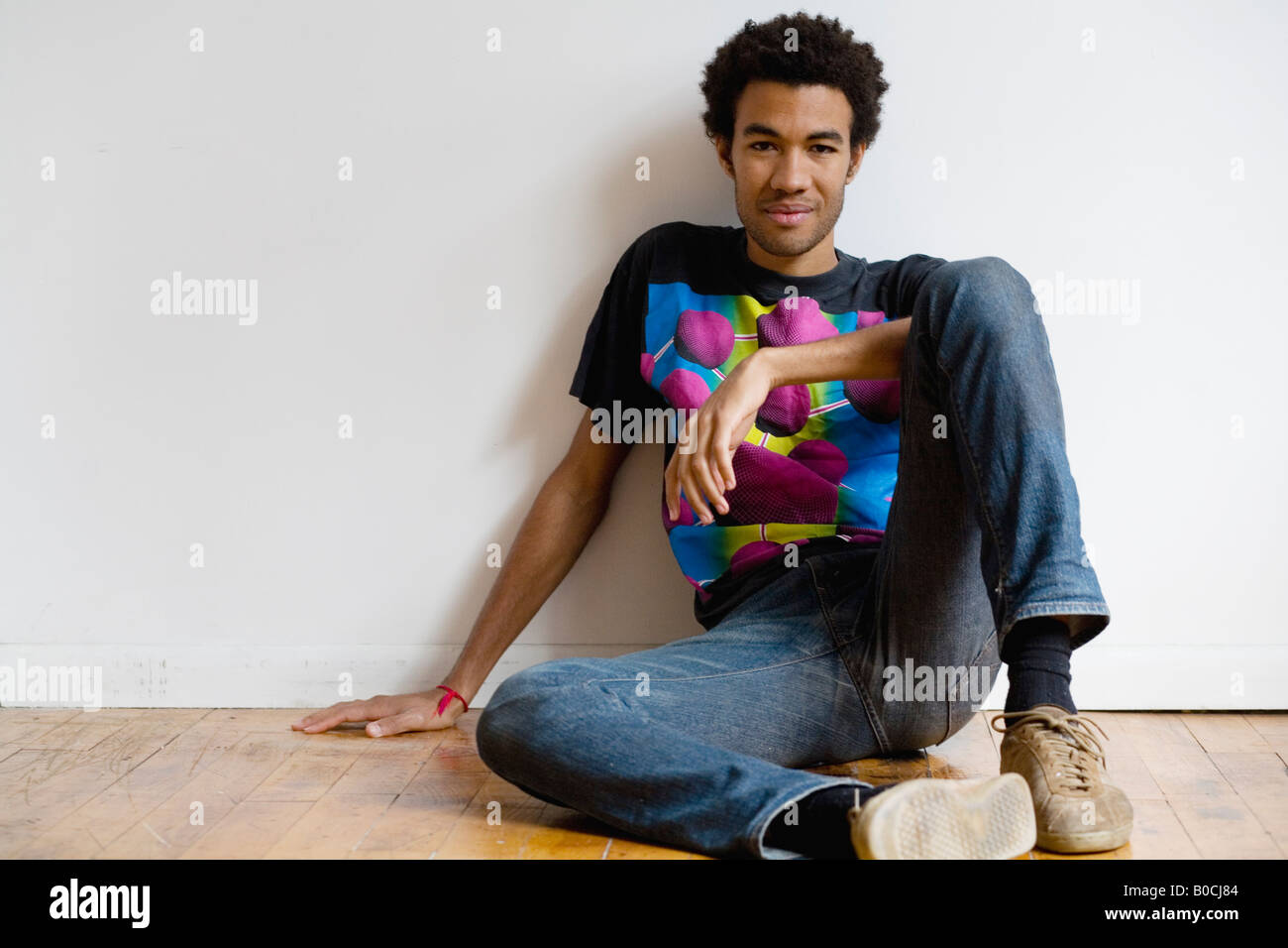 young man sitting on floor Stock Photo - Alamy