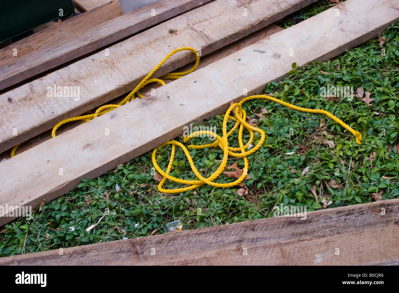 Yellow rope and wood boards laying on the ground Stock Photo - Alamy