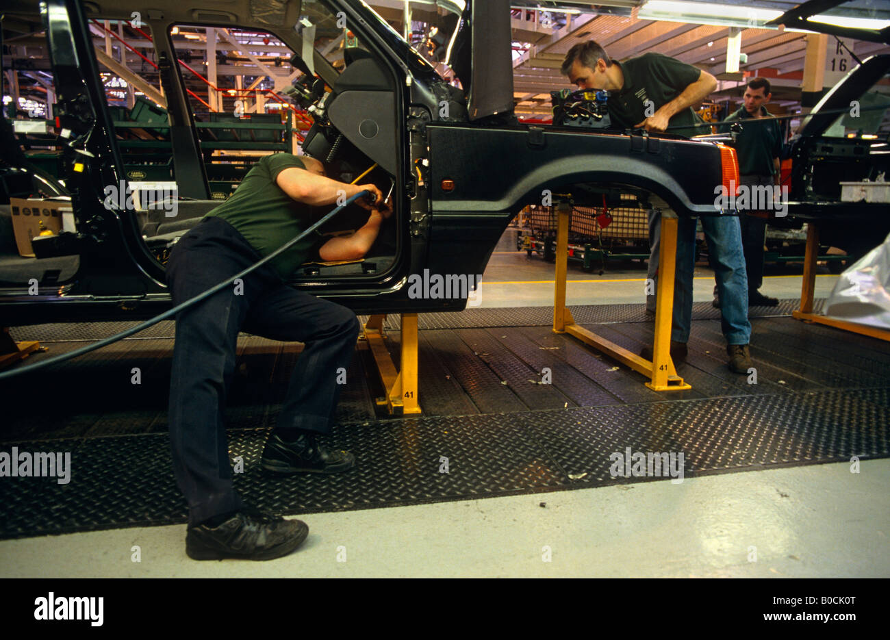 Workers construct luxury Range Rover 4x4 cars on the production line ...