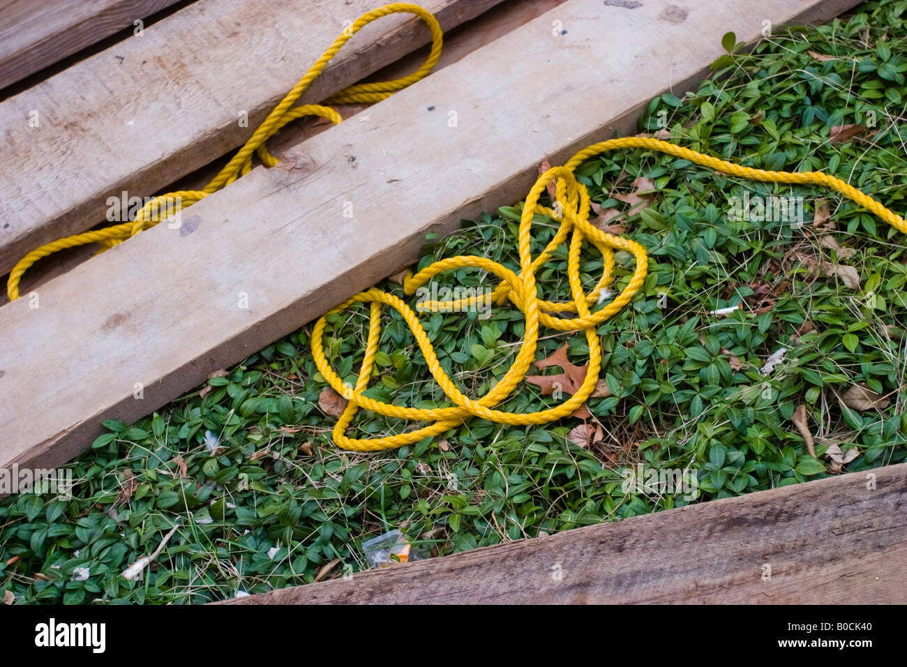 Yellow rope and wood boards laying on the ground Stock Photo - Alamy
