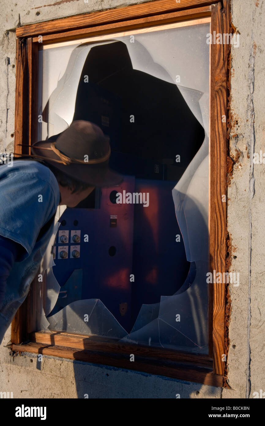 Man looking through broken window at Palm Springs California ...
