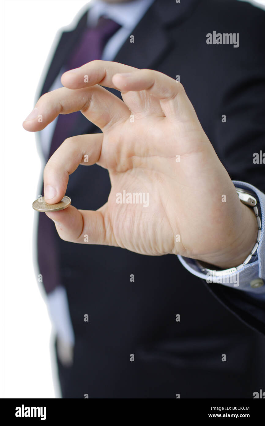 Person in a suit holding a coin in his hand Stock Photo - Alamy