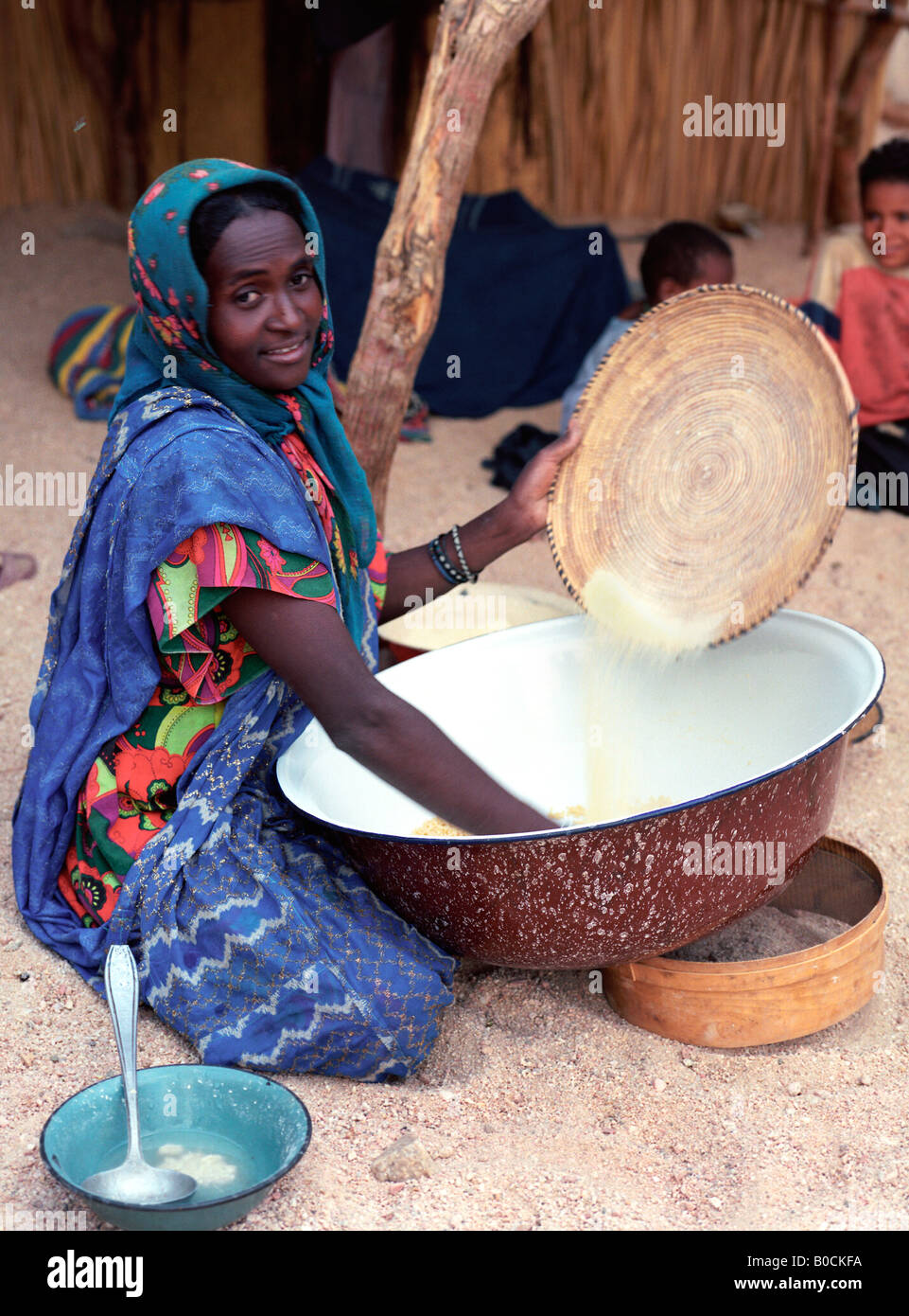 A Tuareg woman prepares couscous Stock Photo - Alamy