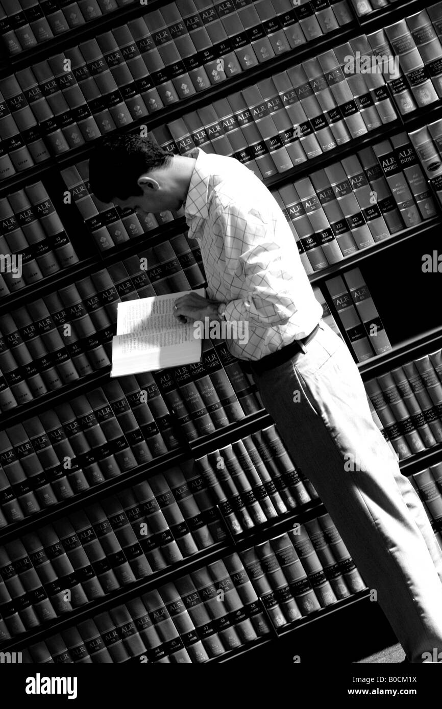 Student/Person reading in a library Stock Photo - Alamy
