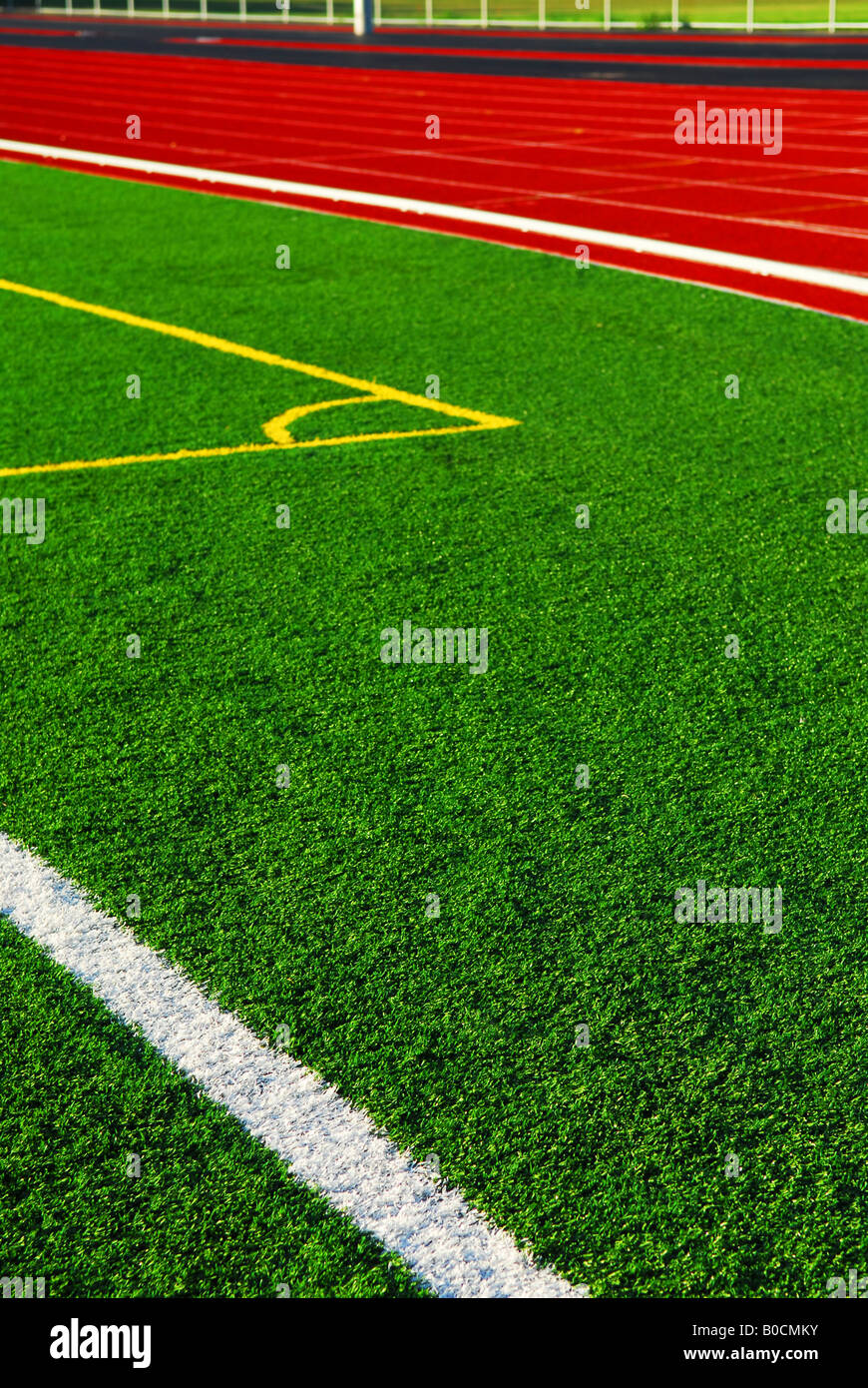 Red racetrack and green sports field with artificial grass Stock Photo ...