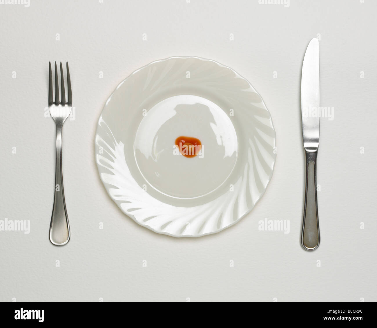 SINGLE BAKED BEAN ON WHITE PLATE WITH STEEL KNIFE AND FORK Stock Photo ...