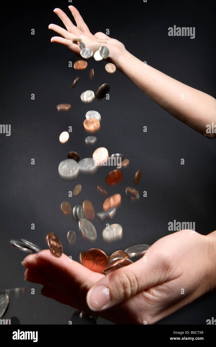 Hand dropping coins hi-res stock photography and images - Alamy