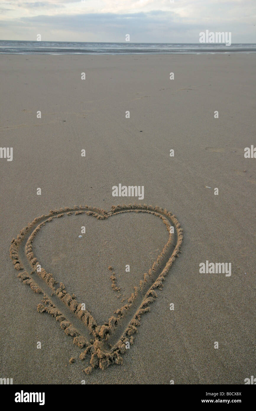 A Love Heart drawn in the sand on a beach at sunset Stock Photo - Alamy