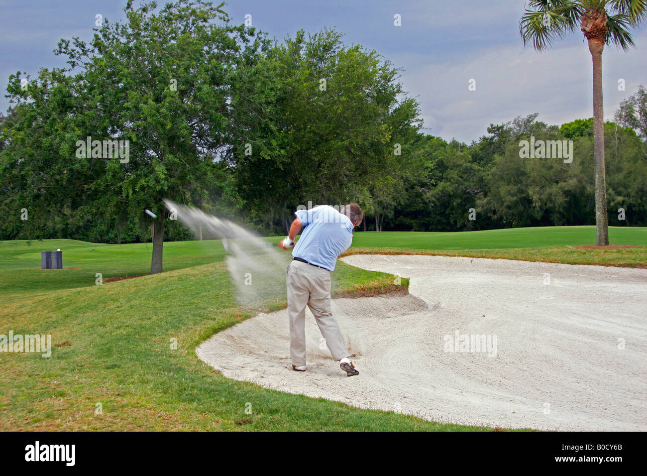 Hitting from sand trap Stock Photo - Alamy