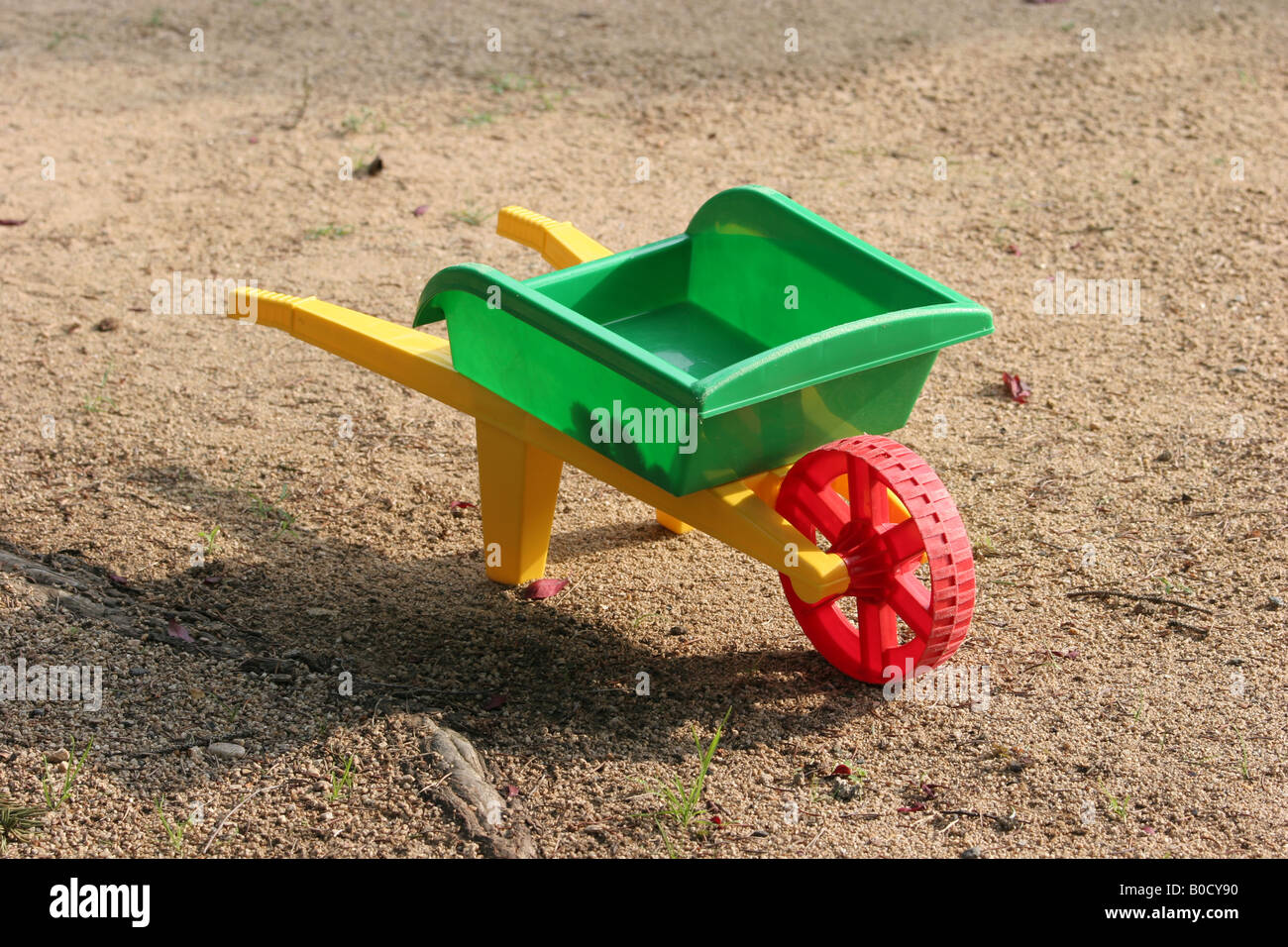Plastic green yellow and red children s wheelbarrow Stock Photo - Alamy