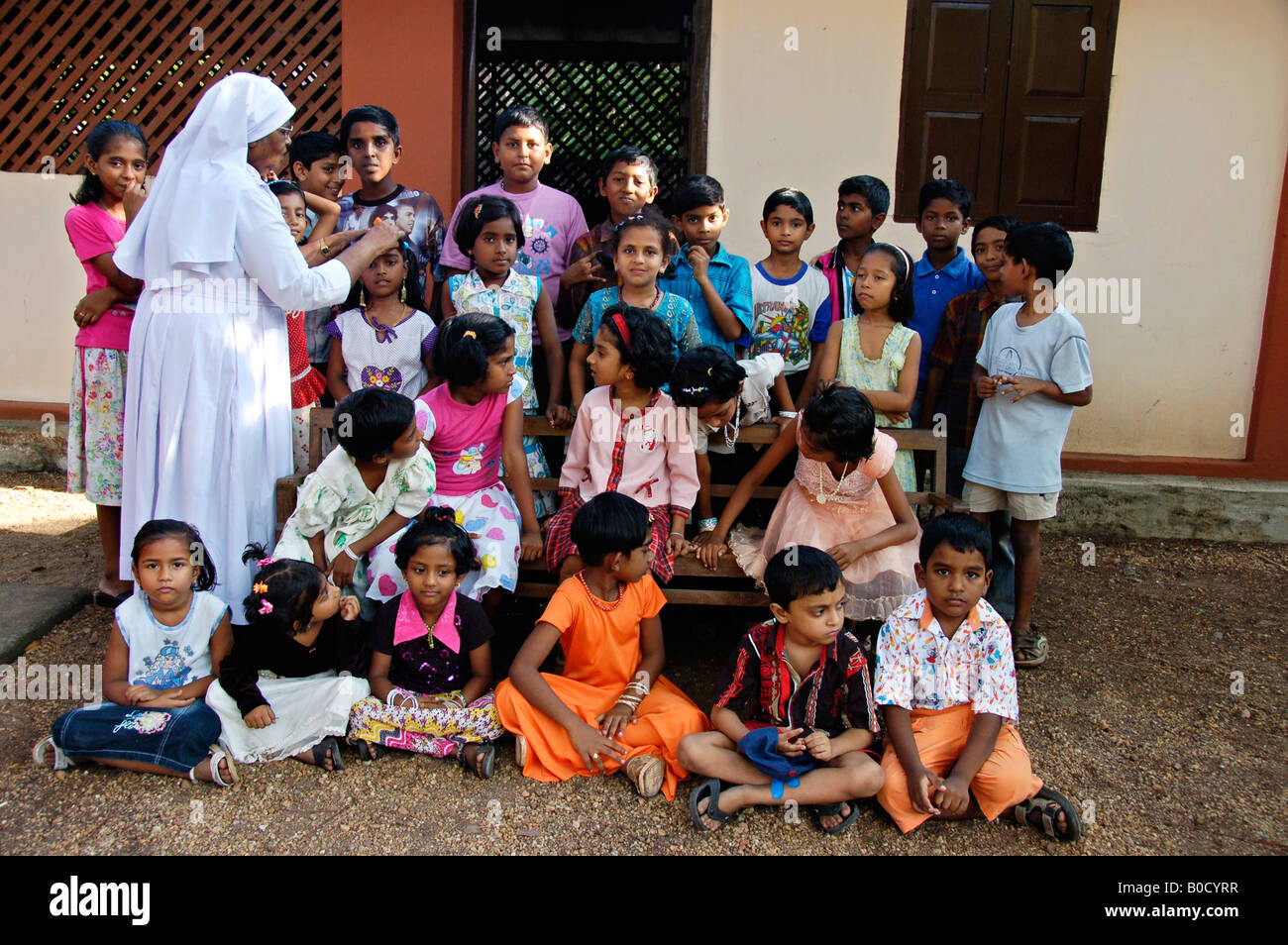 A Catholic Nun teaching children the Ten commandmends. She is strugling ...