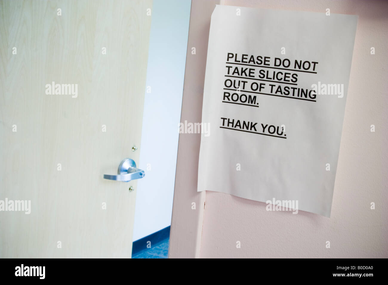 Sign on wall near an open door reading PLEASE DO NOT TAKE SLICES OUT OF ...