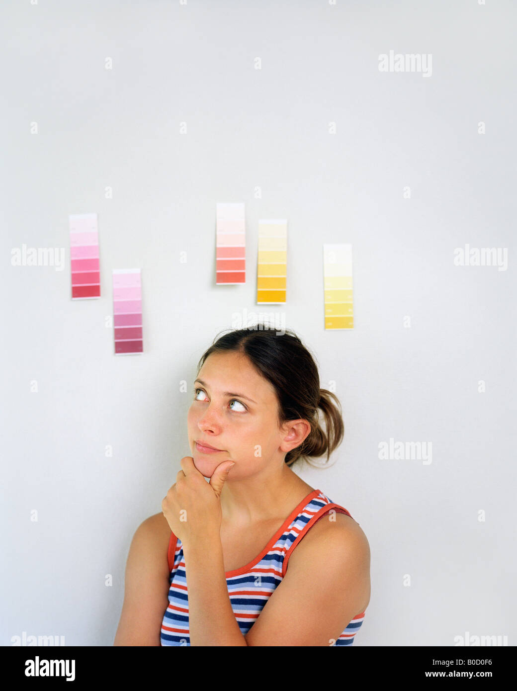 Young woman looking at color swatches on a wall Stock Photo - Alamy