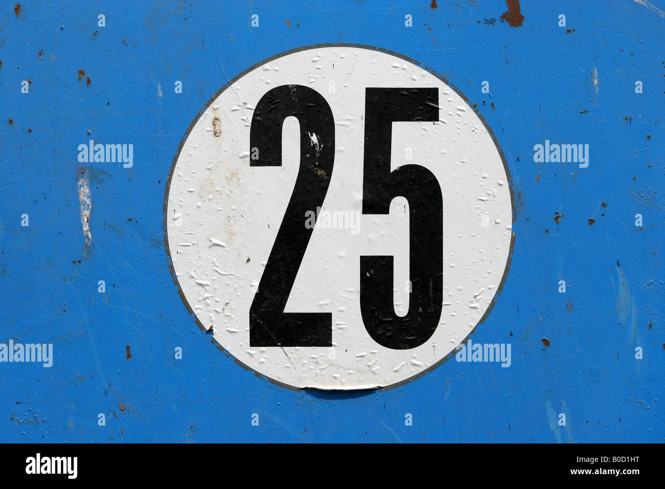 Number 25 sign with black figures in white circle on blue background ...