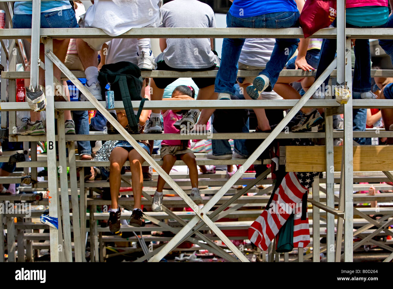 Parade grand stands from the back with two girls sitting and looking ...