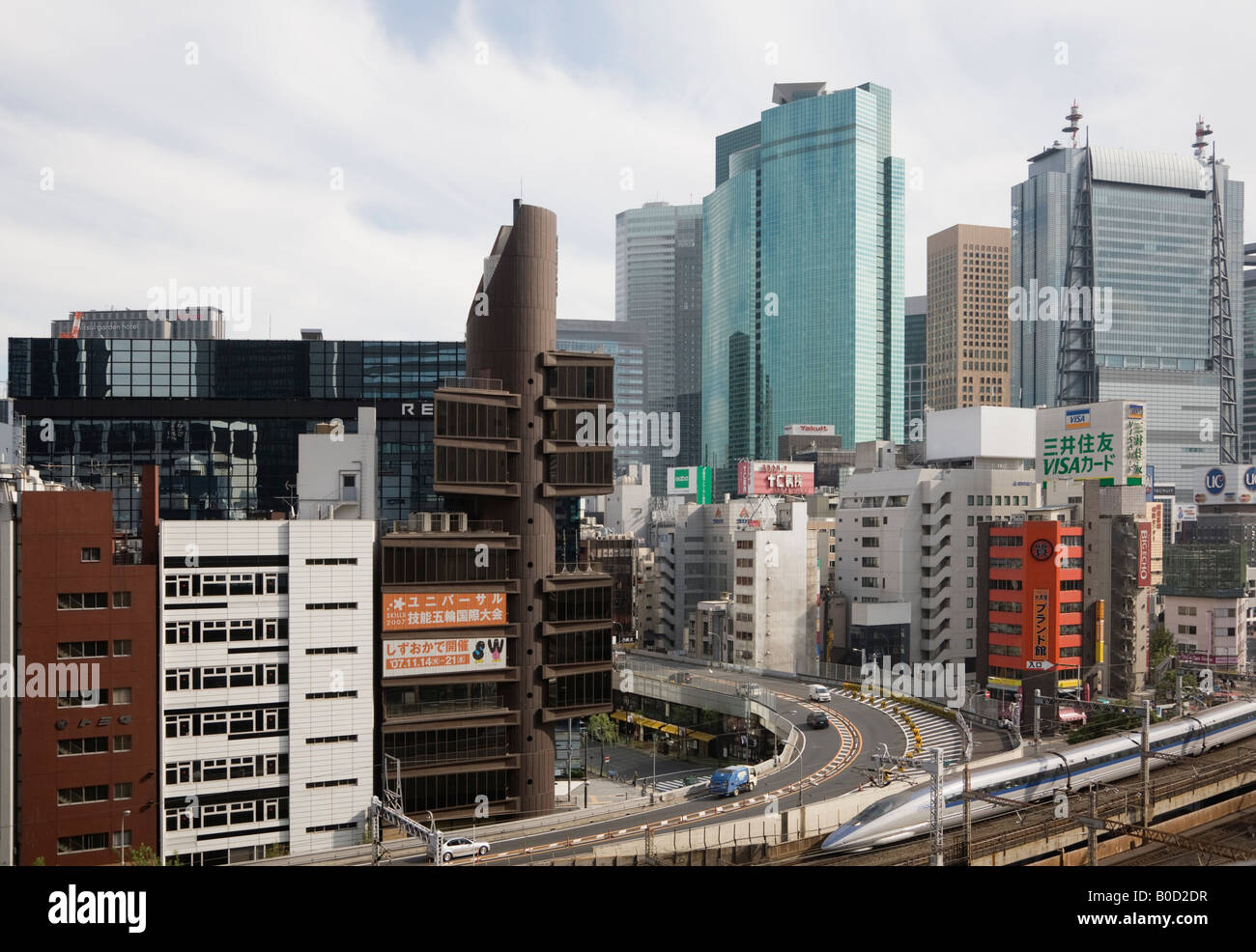 View of Shiodome and a Shinkansen bullet train at Shimbashi Station ...