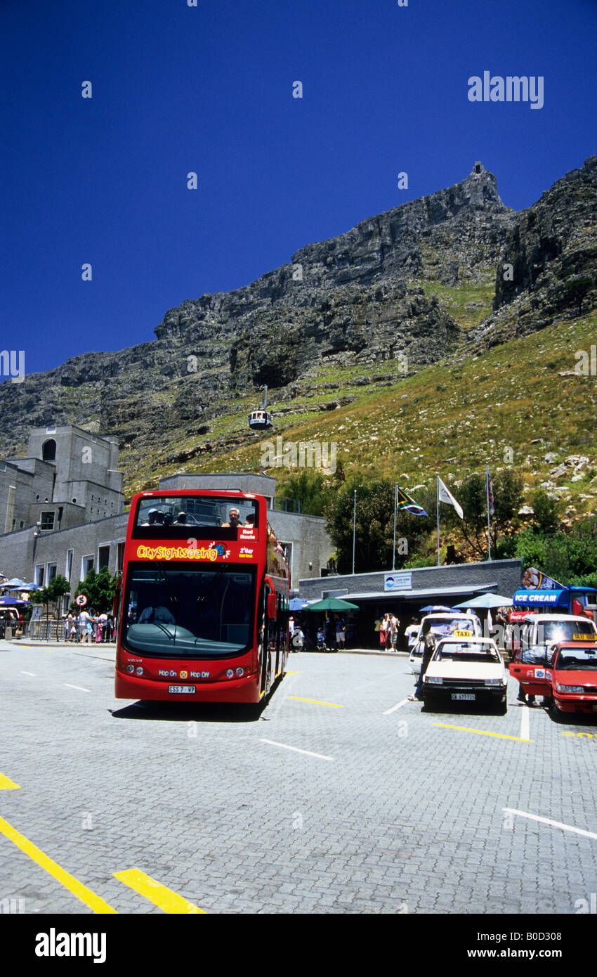 Scene of red sight seeing bus at bottom of cable station Table Mountain ...