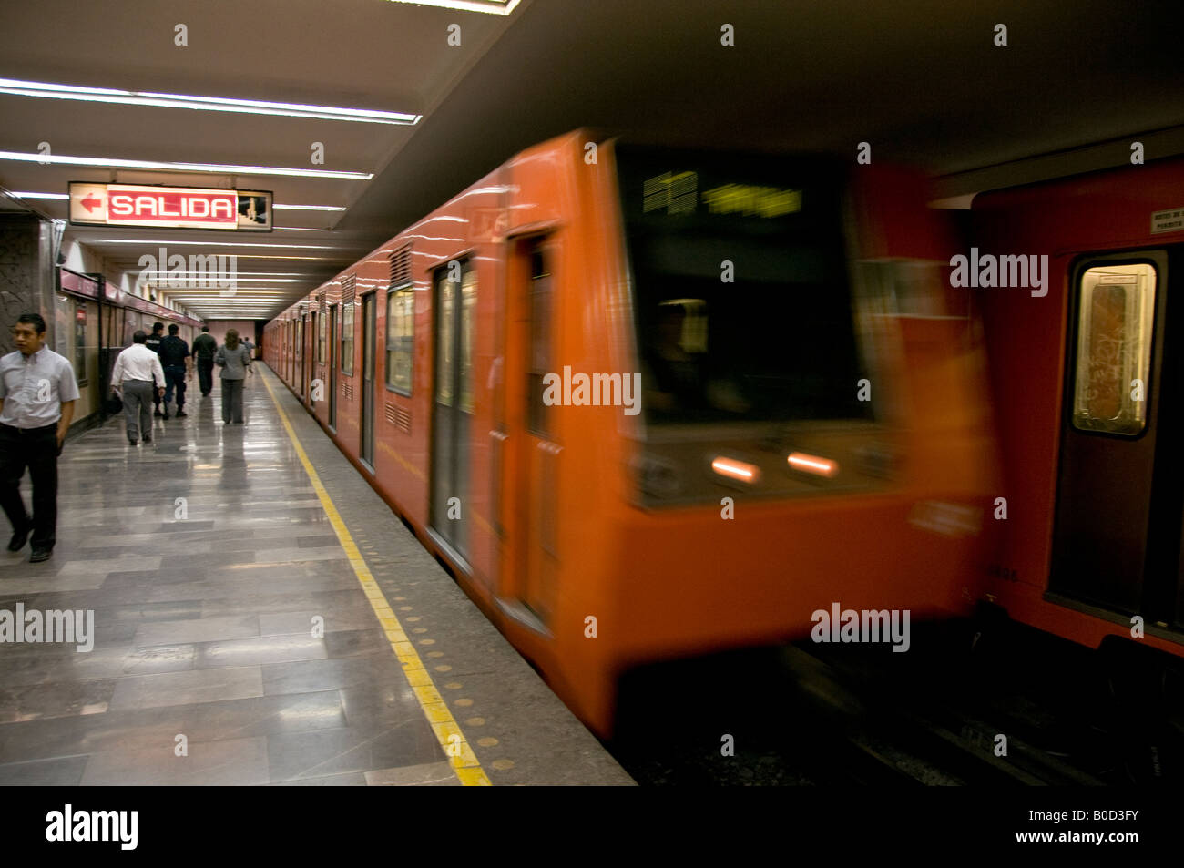 Speeding orange-coloured underground metro train in Mexico City ...