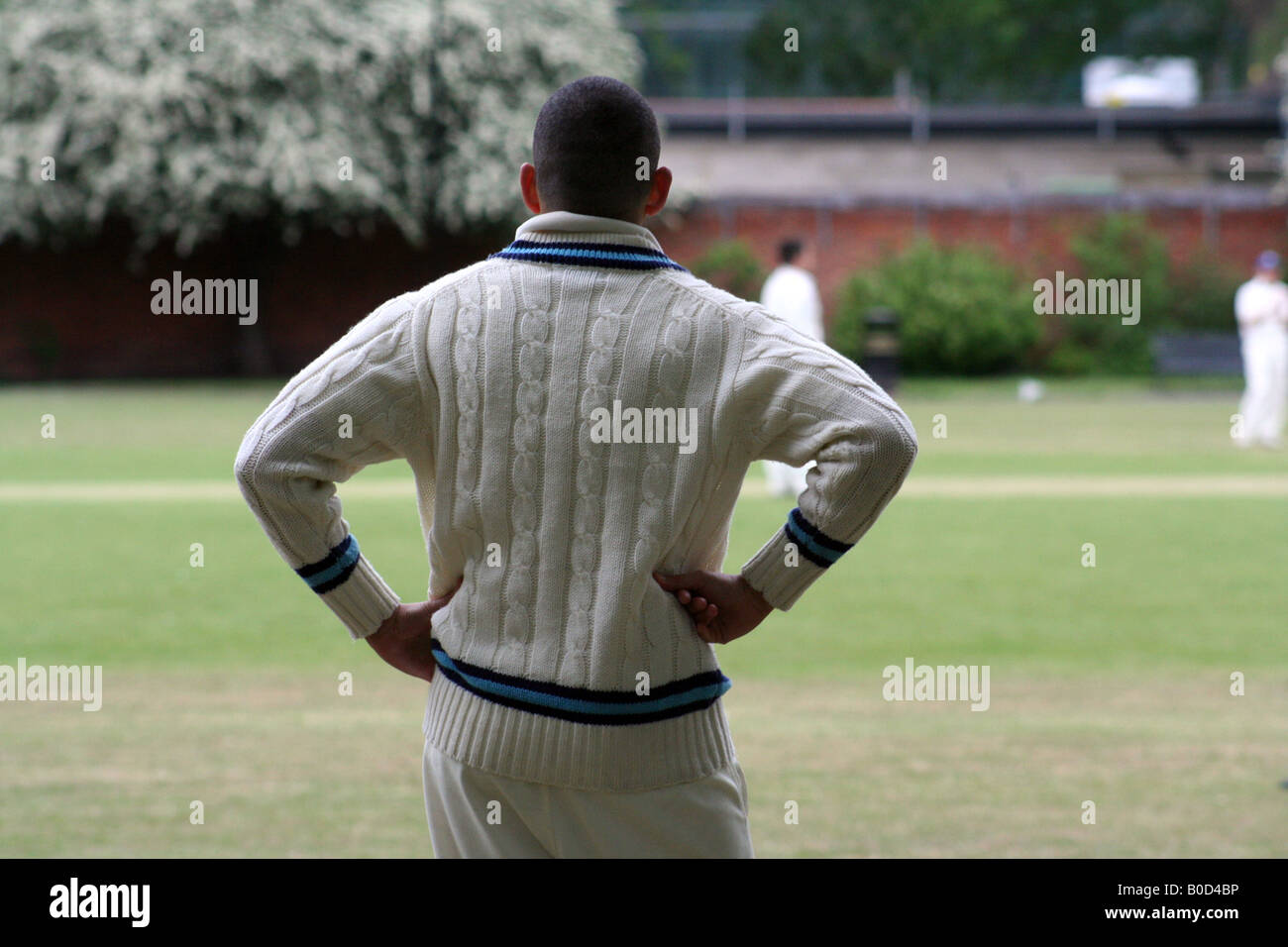 Sunday cricketer stands on the boundary with hands on hips Stock Photo ...