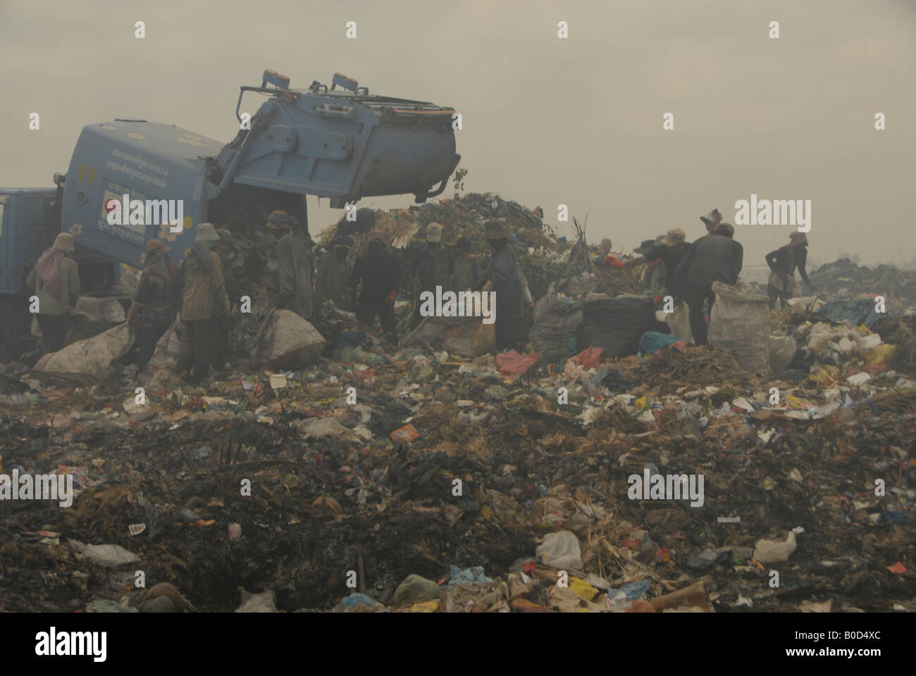 garbage picker, everyone try to get rubbish from garbage truck ...