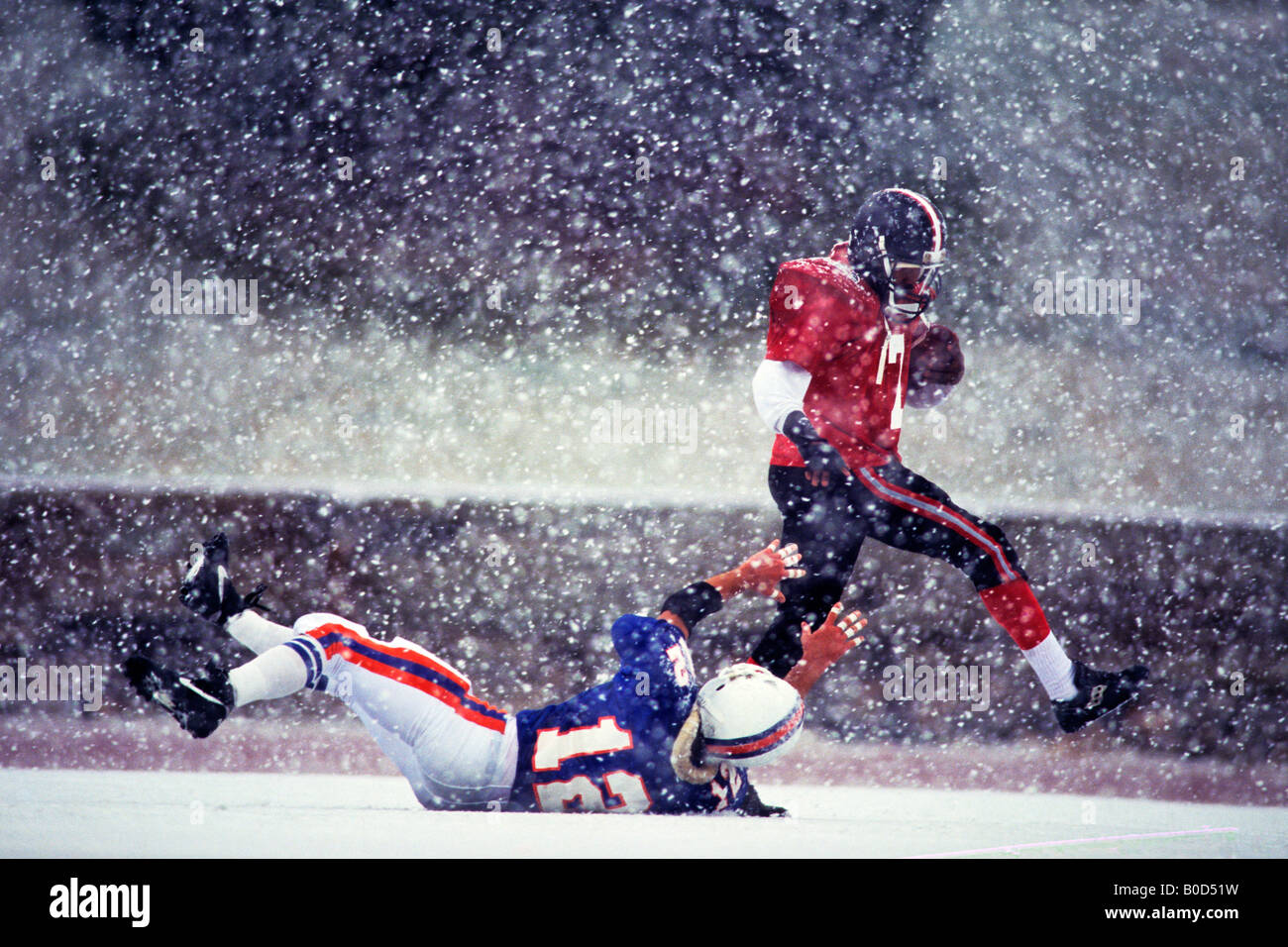 Football players in action during snowy game Stock Photo - Alamy
