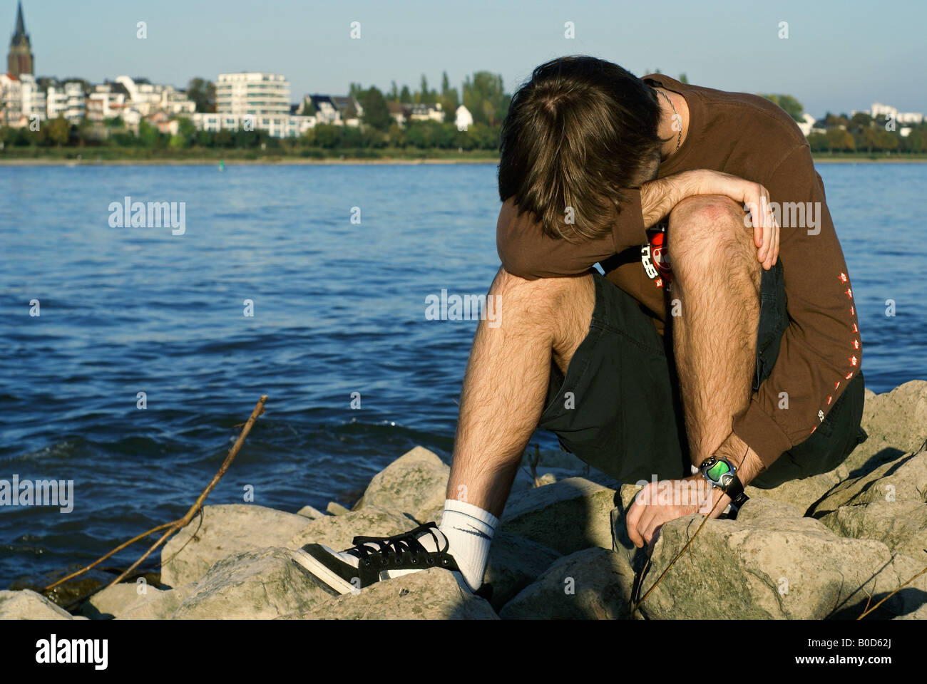 sad man by the Rhine river, in Cologne - Germany Stock Photo - Alamy