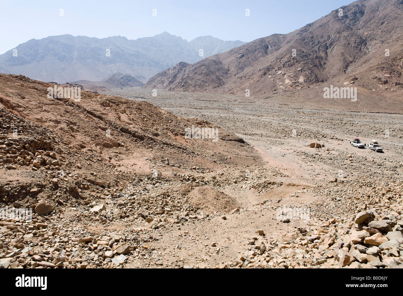 View of the vehicles in wadi bed from the site of Roman town at Mons ...